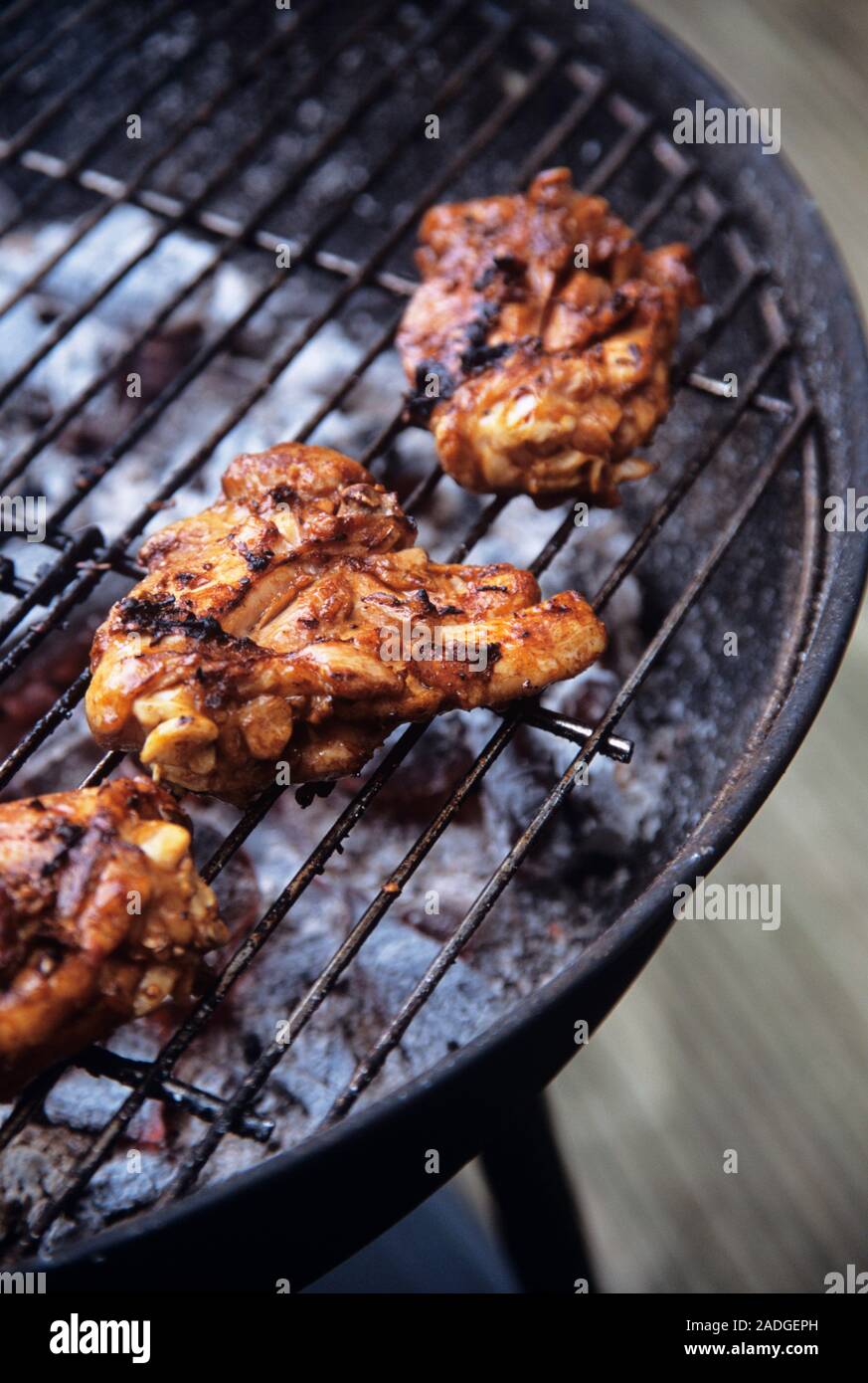 Barbeque. Chicken portions cooking on a barbeque Stock Photo - Alamy