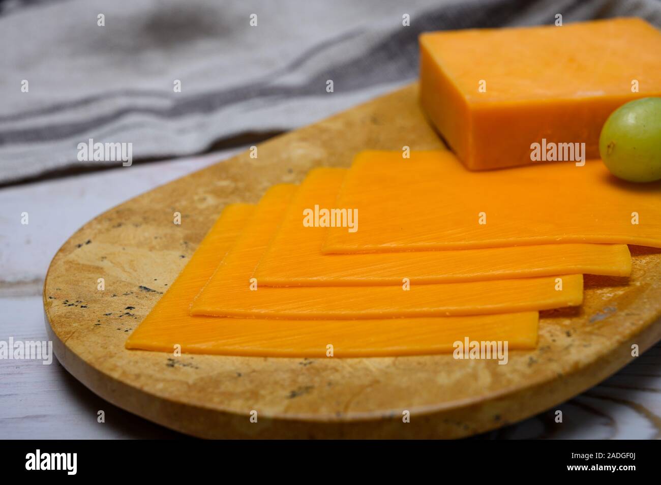 Cheese collection, block and slices of yellow english cheddar cheese ...