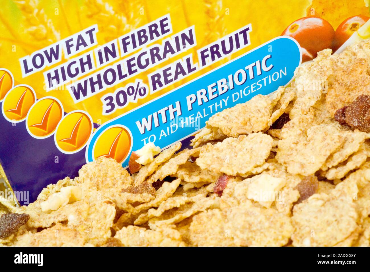Prebiotic cereal. Cereal flakes next to packaging for the cereal. This ...