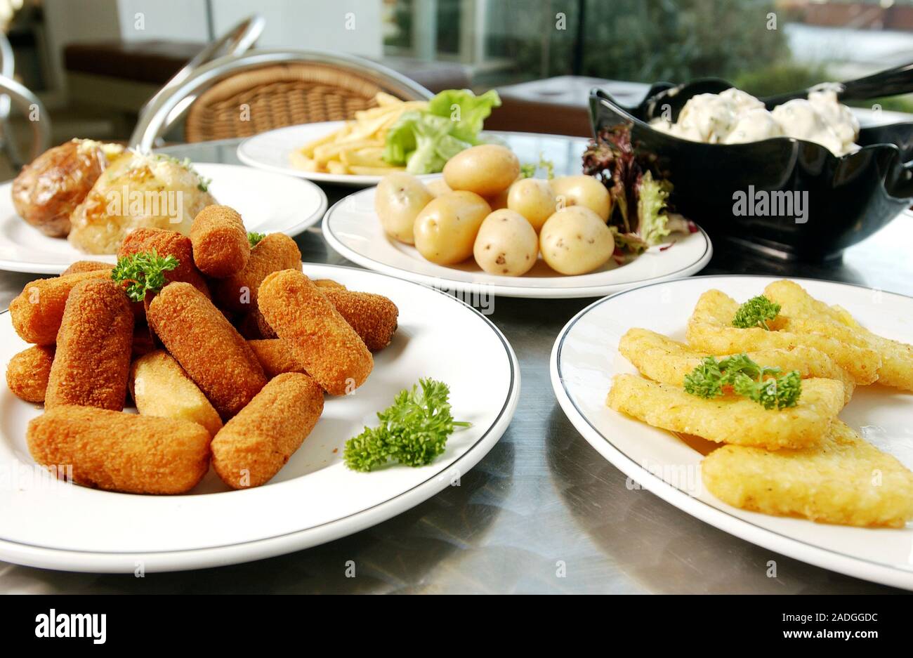 Potato-based foods including chips, potato salad and boiled potatoes on ...