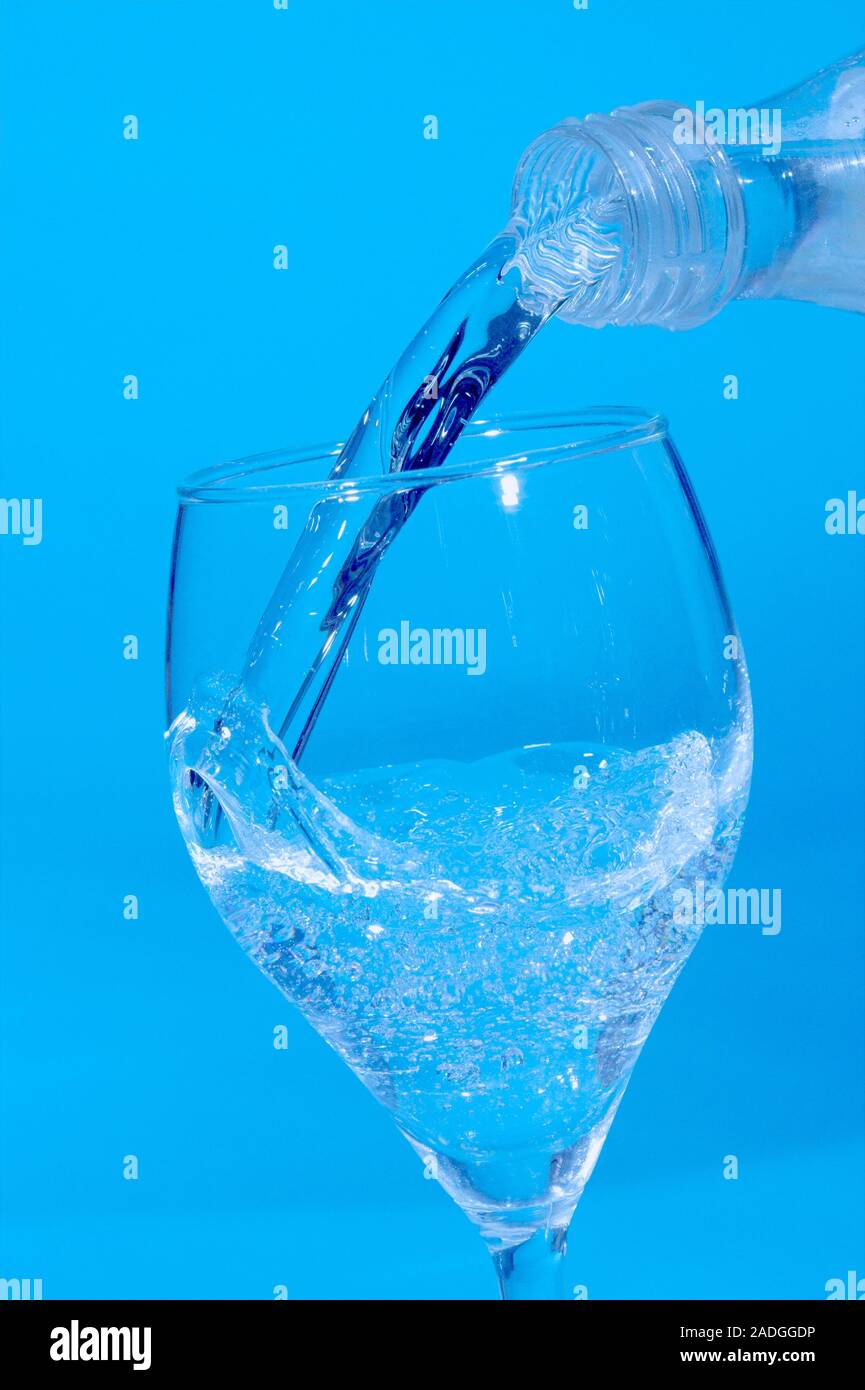 Glass of water. Bottled water being poured into a glass Stock Photo - Alamy