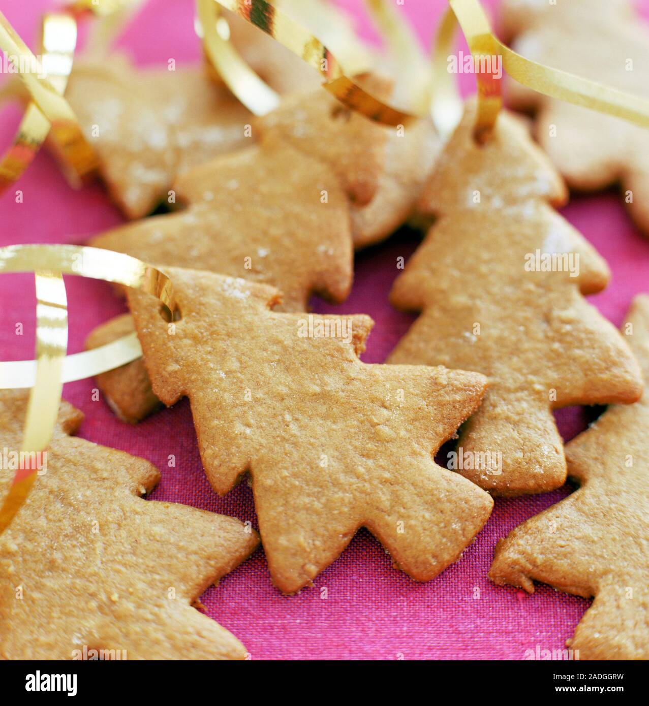 Christmas tree shaped biscuits with gold hanging ribbon Stock Photo - Alamy