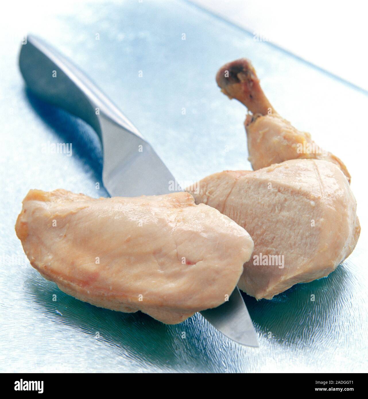 Chicken leg cut in half with a knife Stock Photo - Alamy