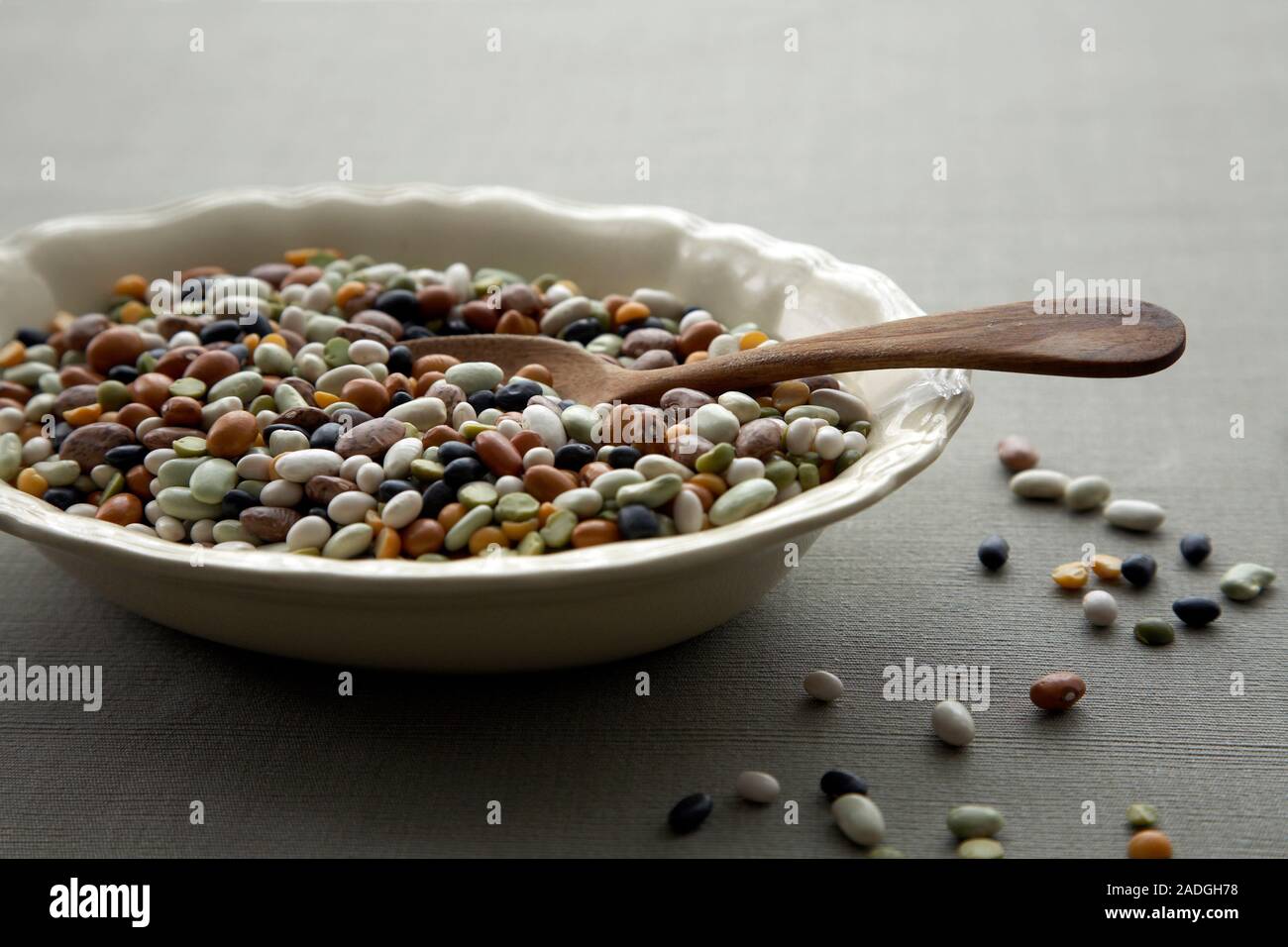 Dried pulses. Spoon in a bowl of mixed dried pulses containing ...