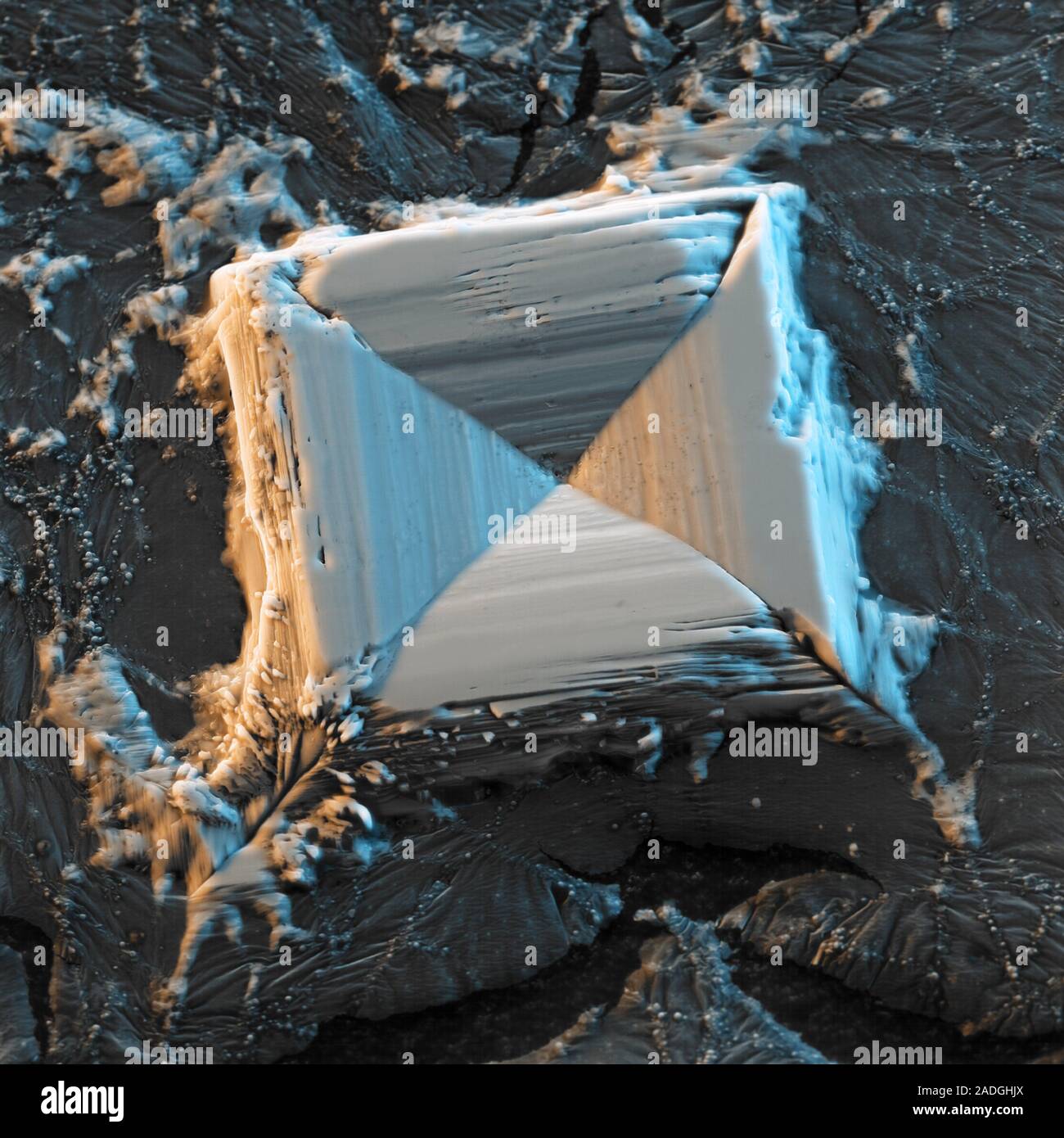 Common salt crystals. Coloured scanning electron micrograph (SEM) of ...