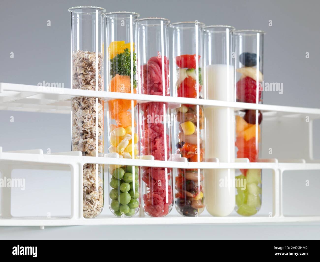 Balanced diet. Test tubes containing the components of a healthy diet ...