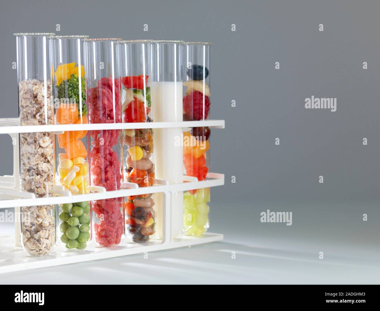 Balanced diet. Test tubes containing the components of a healthy diet ...