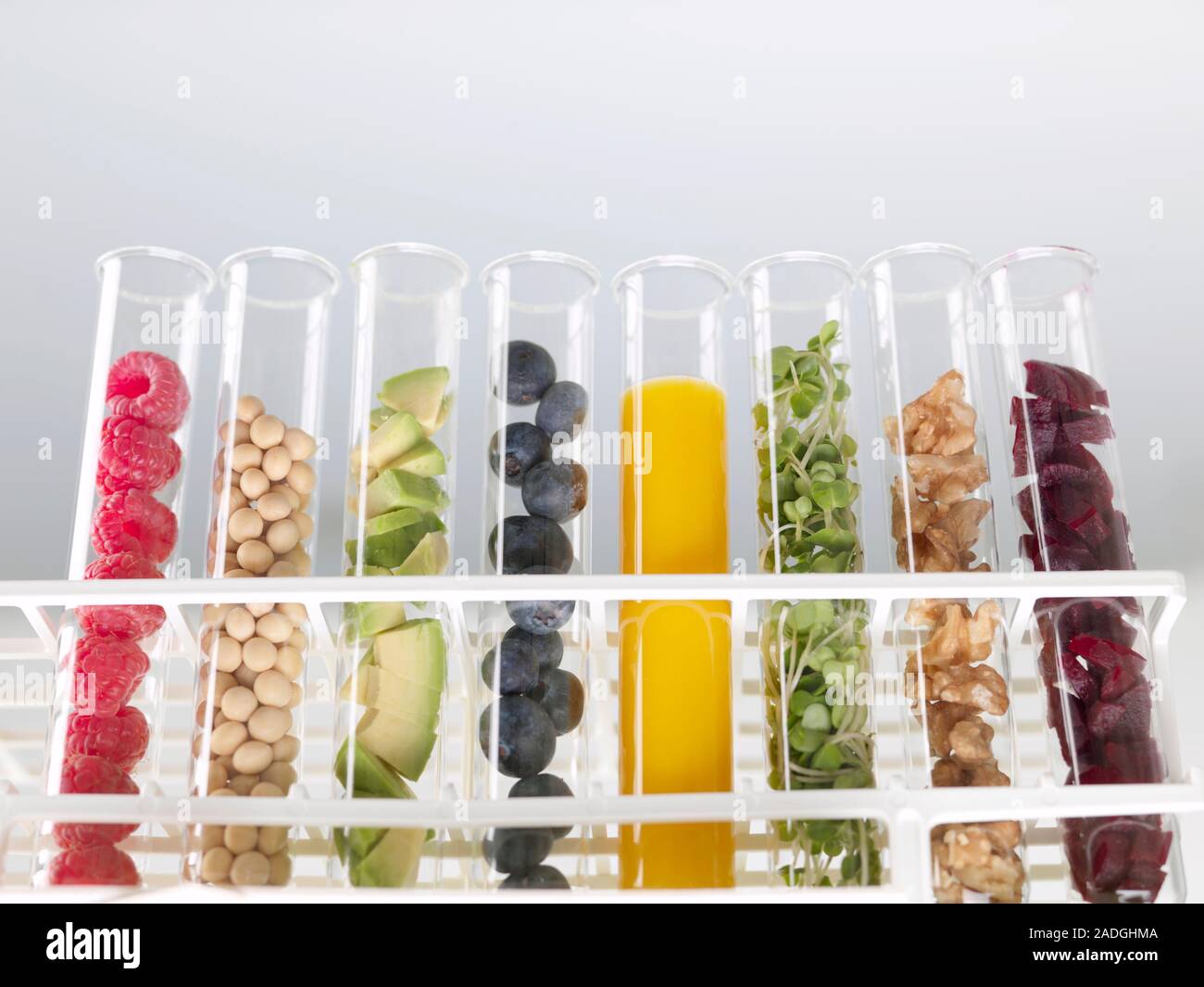 Superfoods. Test tubes containing a variety of superfoods. From left to ...