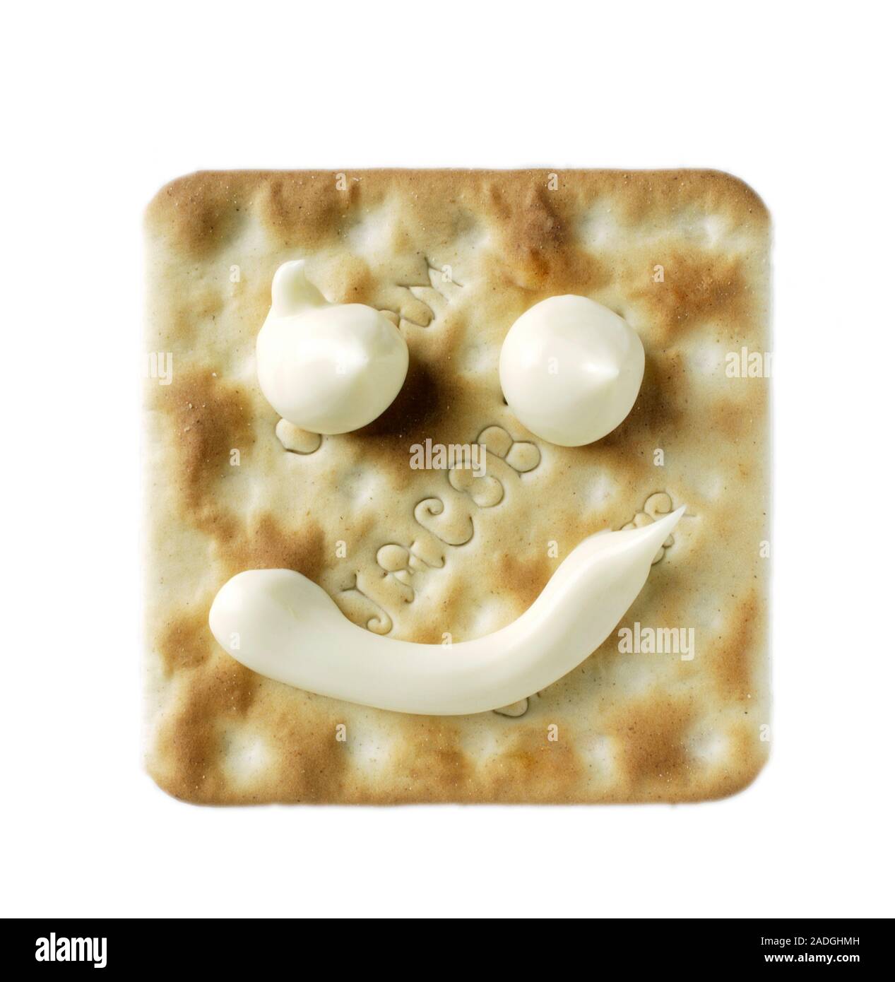 Cracker, with a smiley face drawn in cheese Stock Photo - Alamy