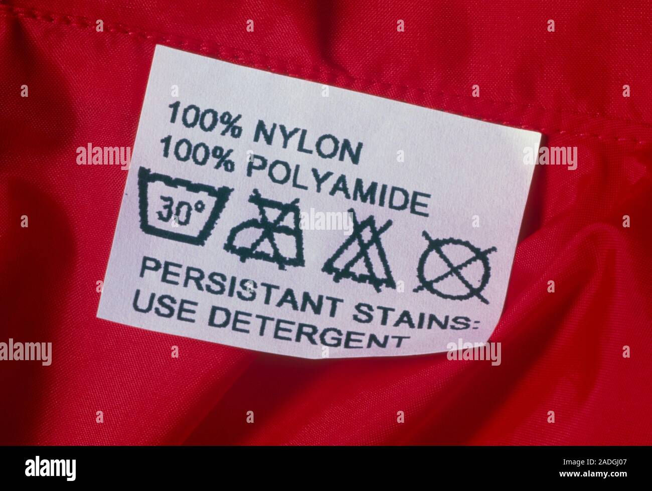 Clothes label. Close-up of the label on a nylon garment. The symbols ...