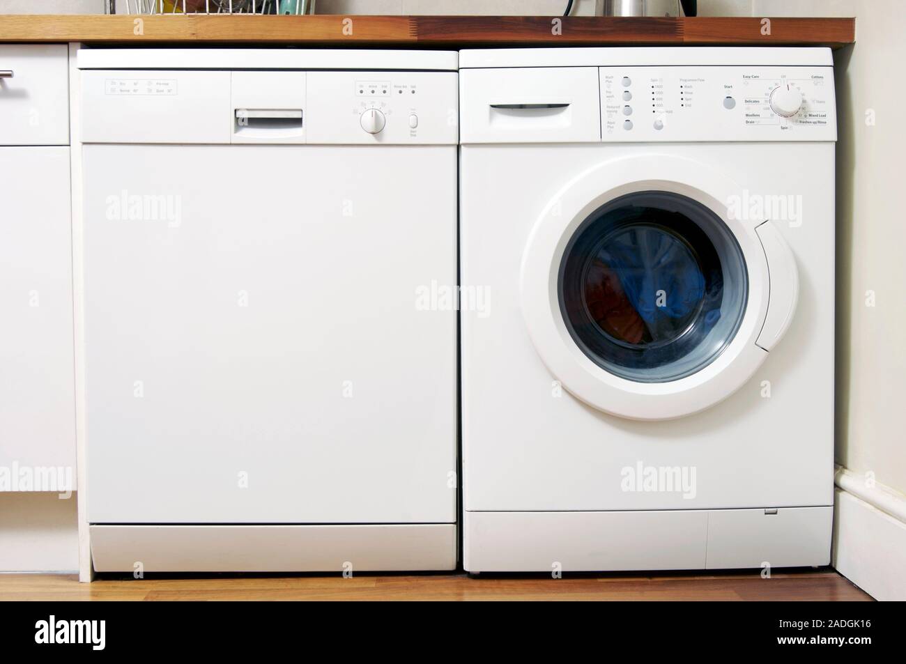 Domestic dishwasher (left) and washing machine (right) in a kitchen ...