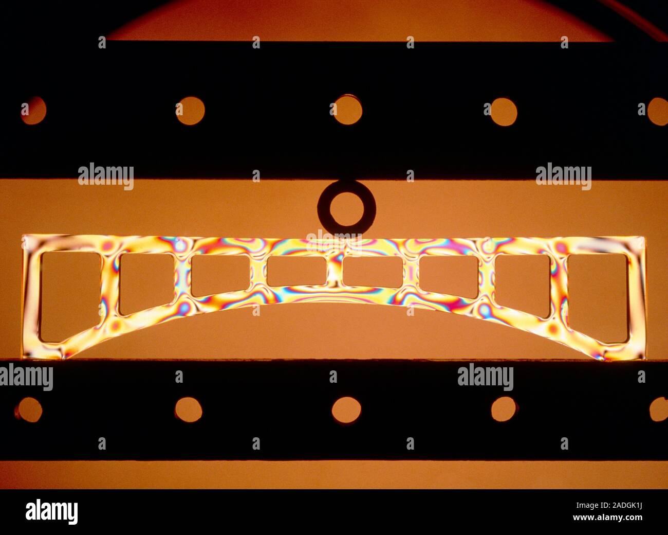 Coloured light interference patterns on a plastic model of a suspension ...