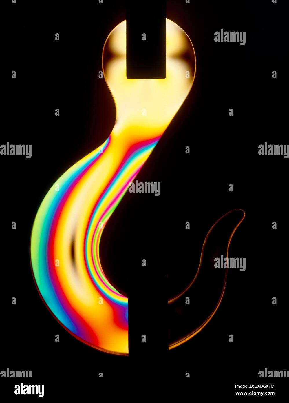 Coloured interference stress patterns appear in a plastic model of a ...
