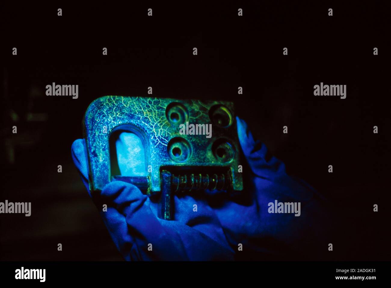 Crack Test Researchers Hand Holding A Metal Component Under