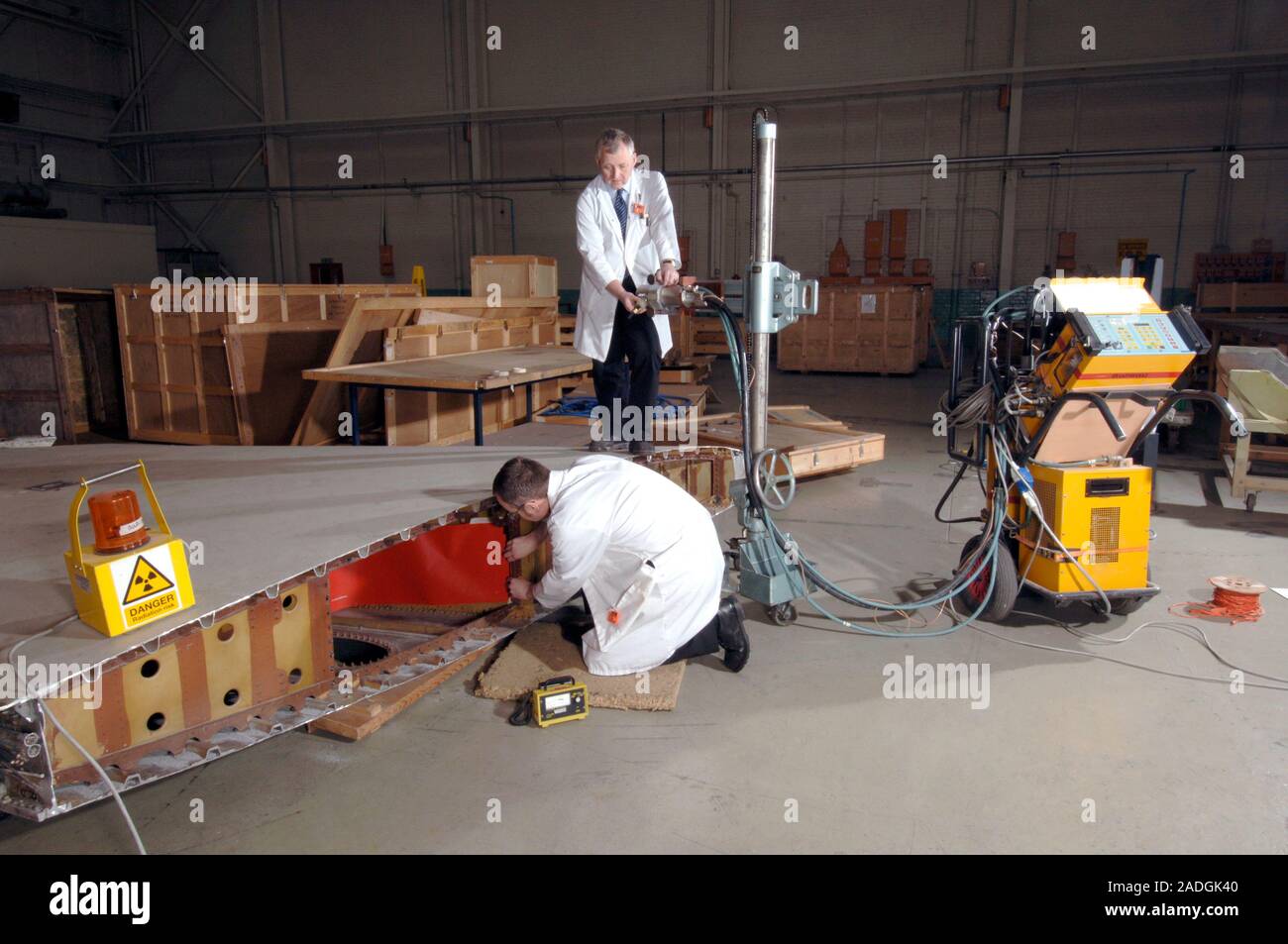 MODEL RELEASED. X-ray inspection of aircraft parts. Engineers setting ...