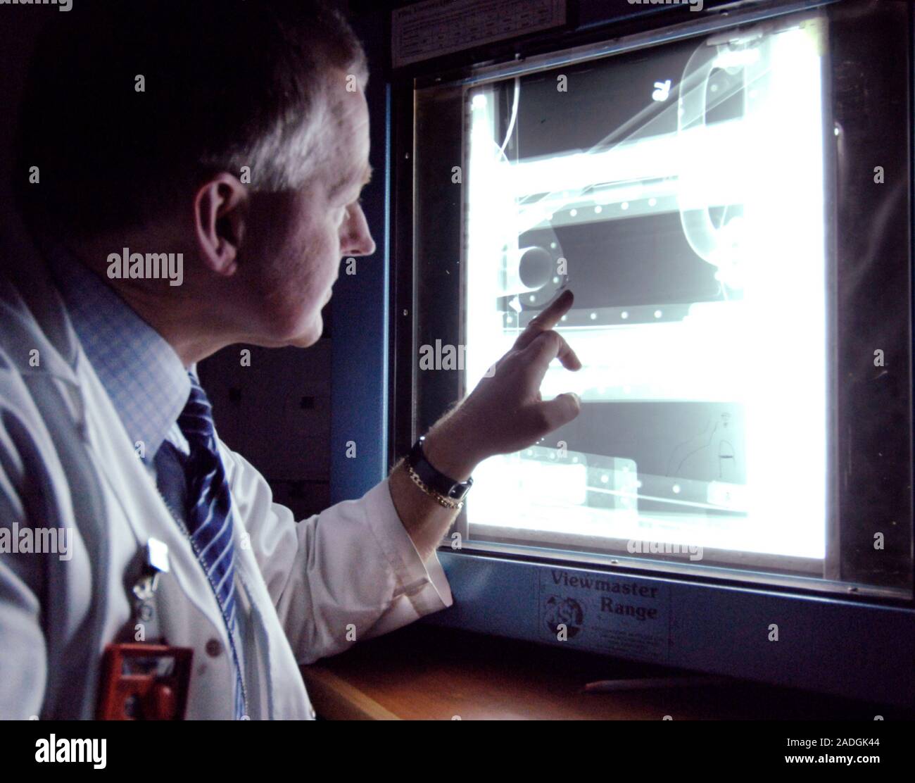 MODEL RELEASED. X-ray inspection of aircraft parts. Engineer studying ...