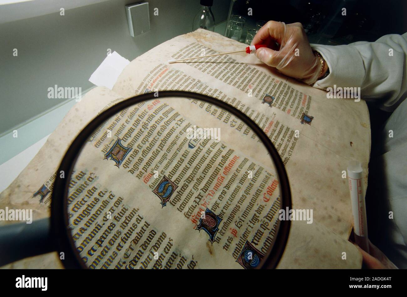 Medieval manuscript. A laboratory researcher tests for the presence of ...
