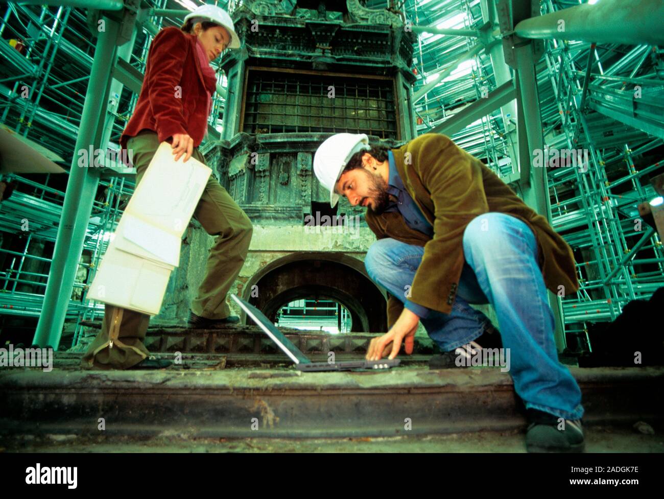 Architectural restoration. Architects carrying out restoration work on ...