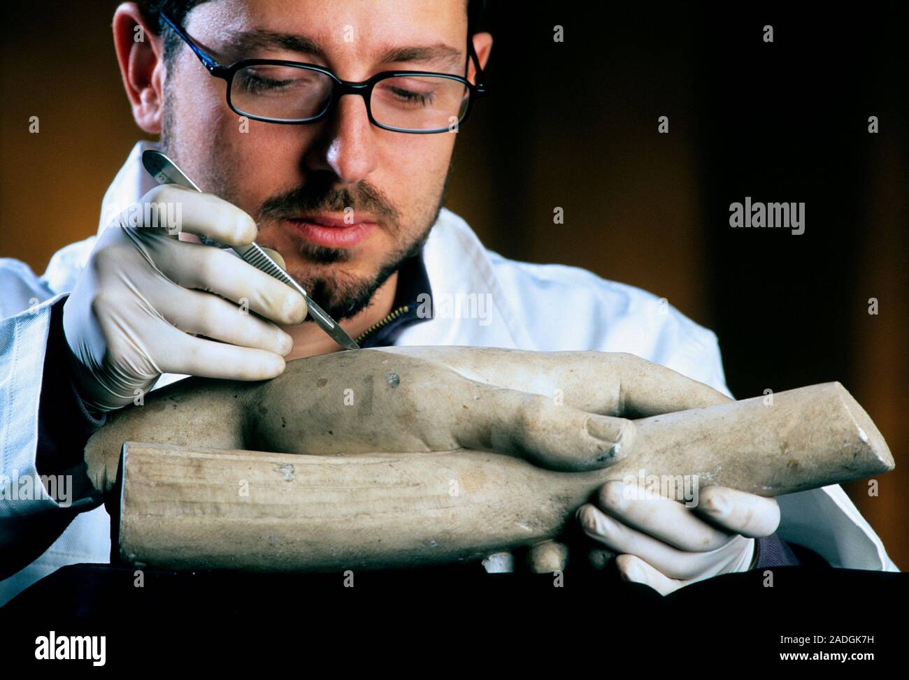 Architectural restoration. Restorer working on a piece of stone ...