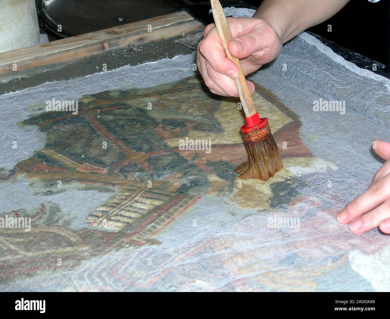 Battle of Issus mosaic reconstruction. Restorer working on a ...