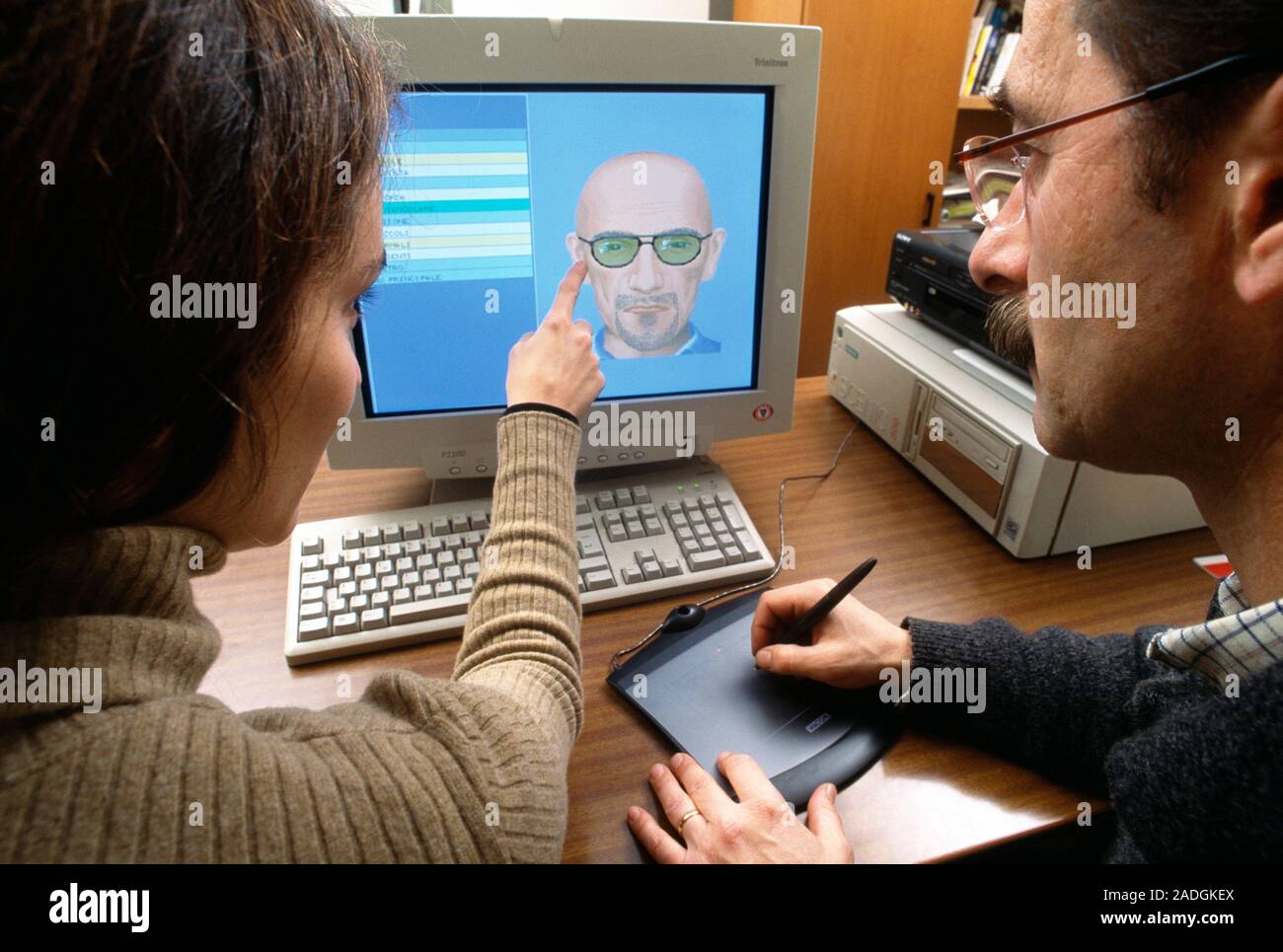 Identikit reconstruction. Crime victim (left) working with a police ...