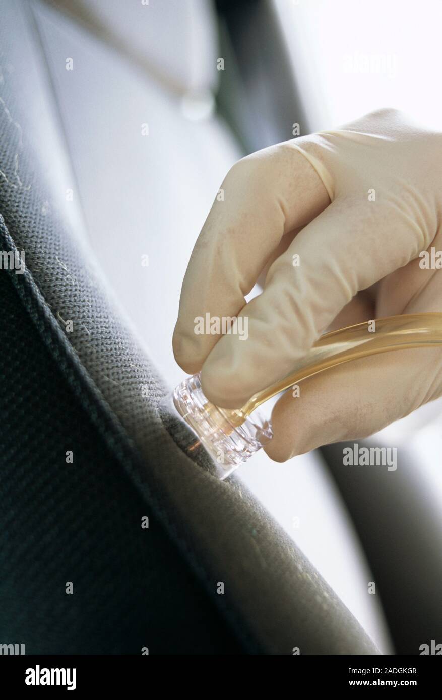 Collecting evidence. Suction tube device being used to collect evidence ...