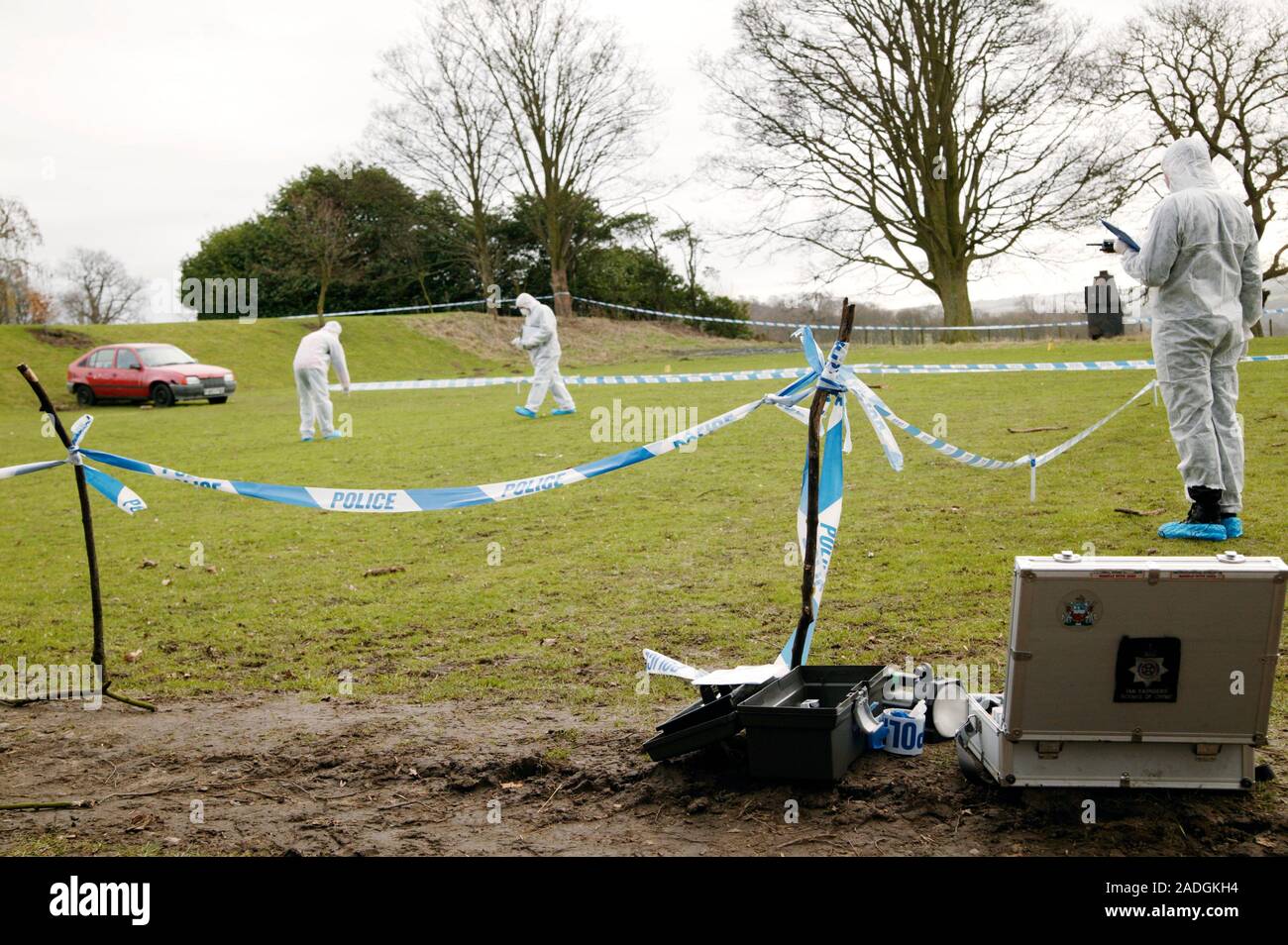 Forensics. Scene of crime officer (SOCO) watching two colleagues ...