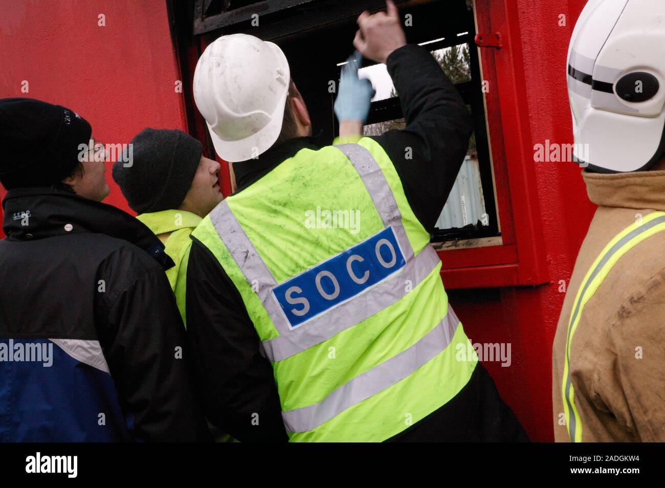Crime scene investigation. Scene of crime officer (SOCO) examnining a ...