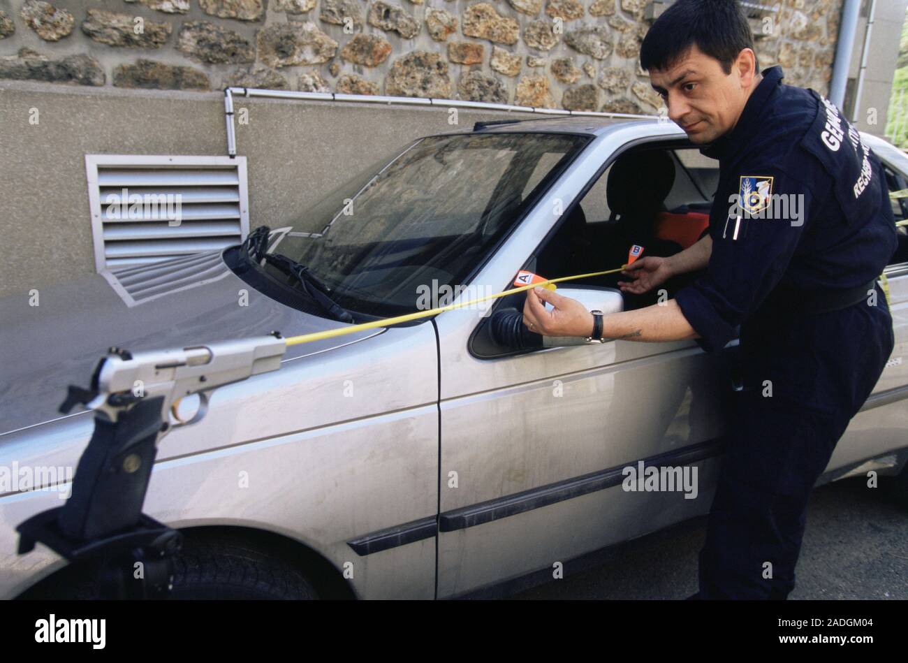 Forensic analysis of a shooting. Policeman with a set-up of the ...