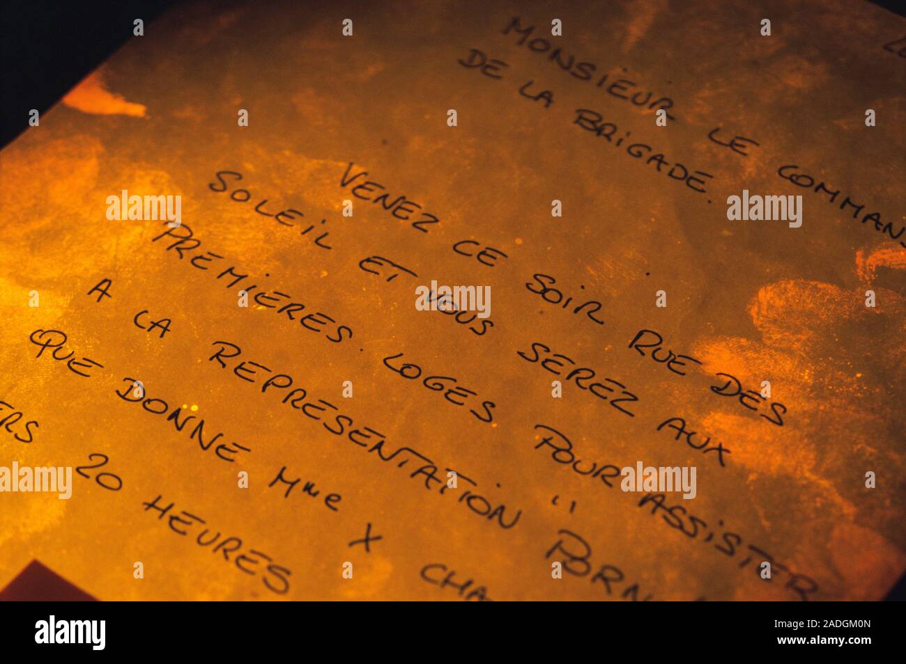 Fingerprint detection. Fingerprints on a letter fluorescing orange ...