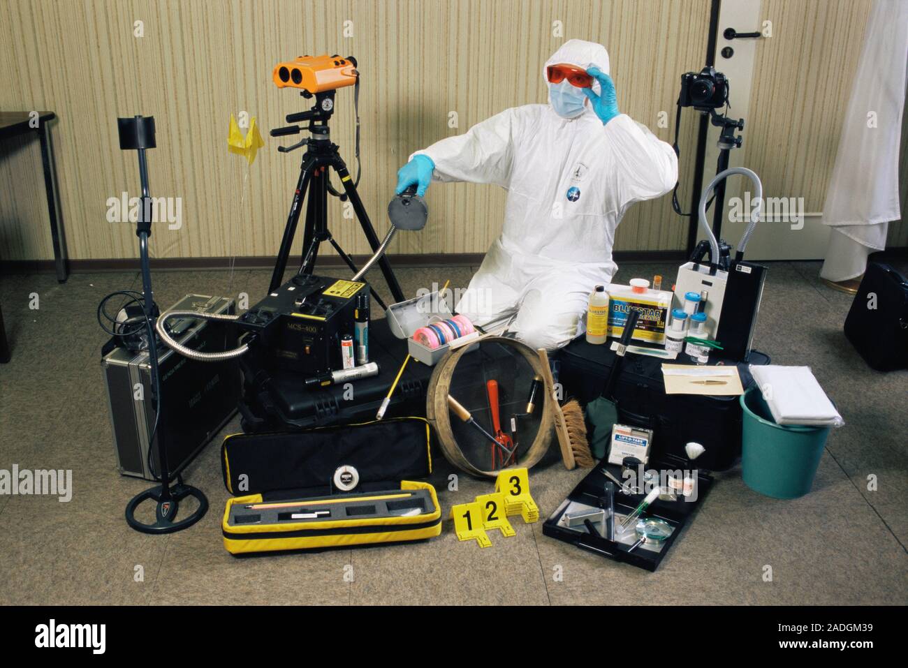 Forensic science equipment. Forensic scientist holding a Mini ...