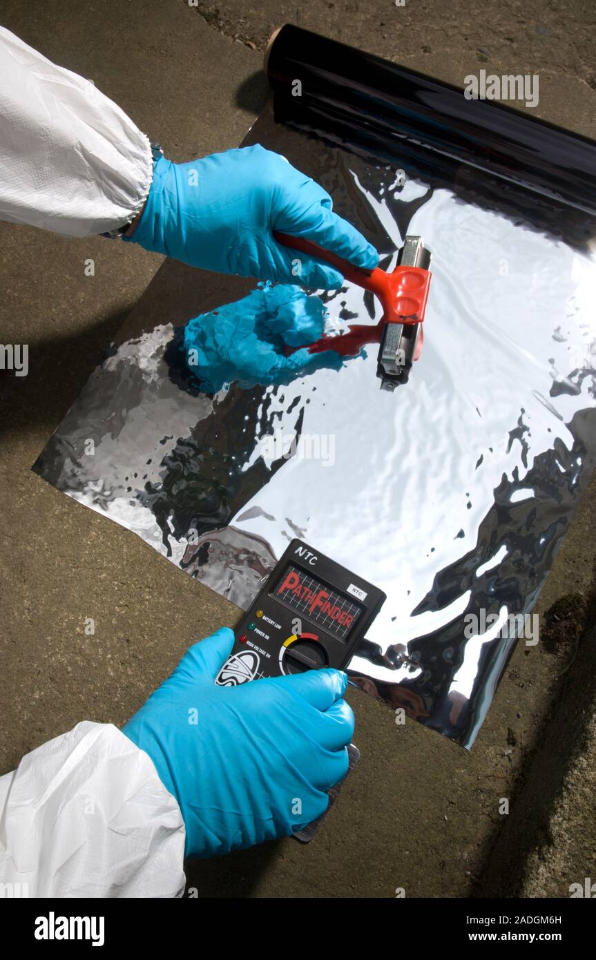 Footprint lifting. Scene of crime officer (SOCO) lifting a footprint at ...