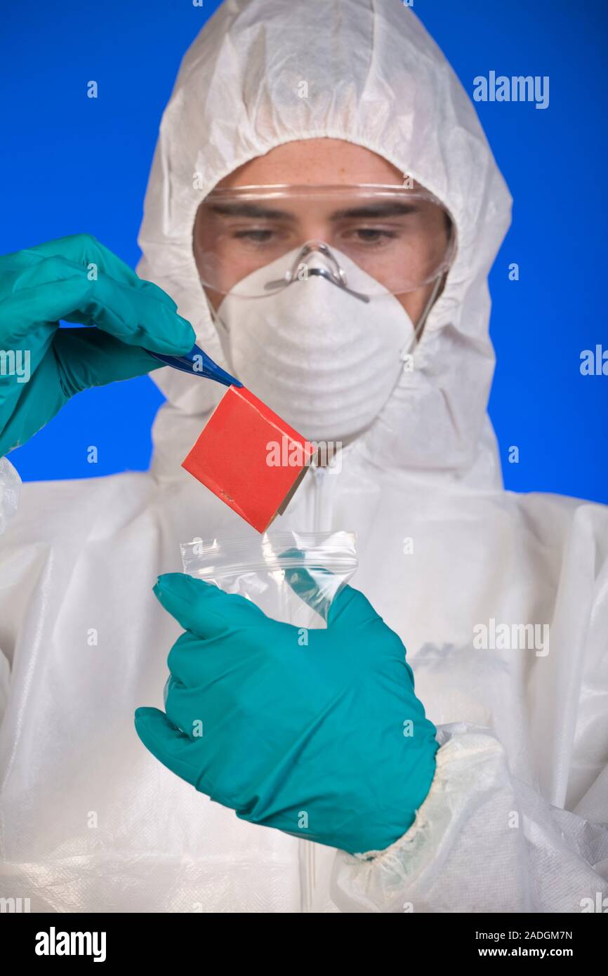MODEL RELEASED. Forensic evidence. Forensic officer using a pair of ...