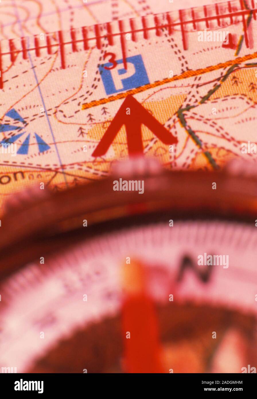 Magnetic compass. Magnetic compass being used with an ordnance survey ...