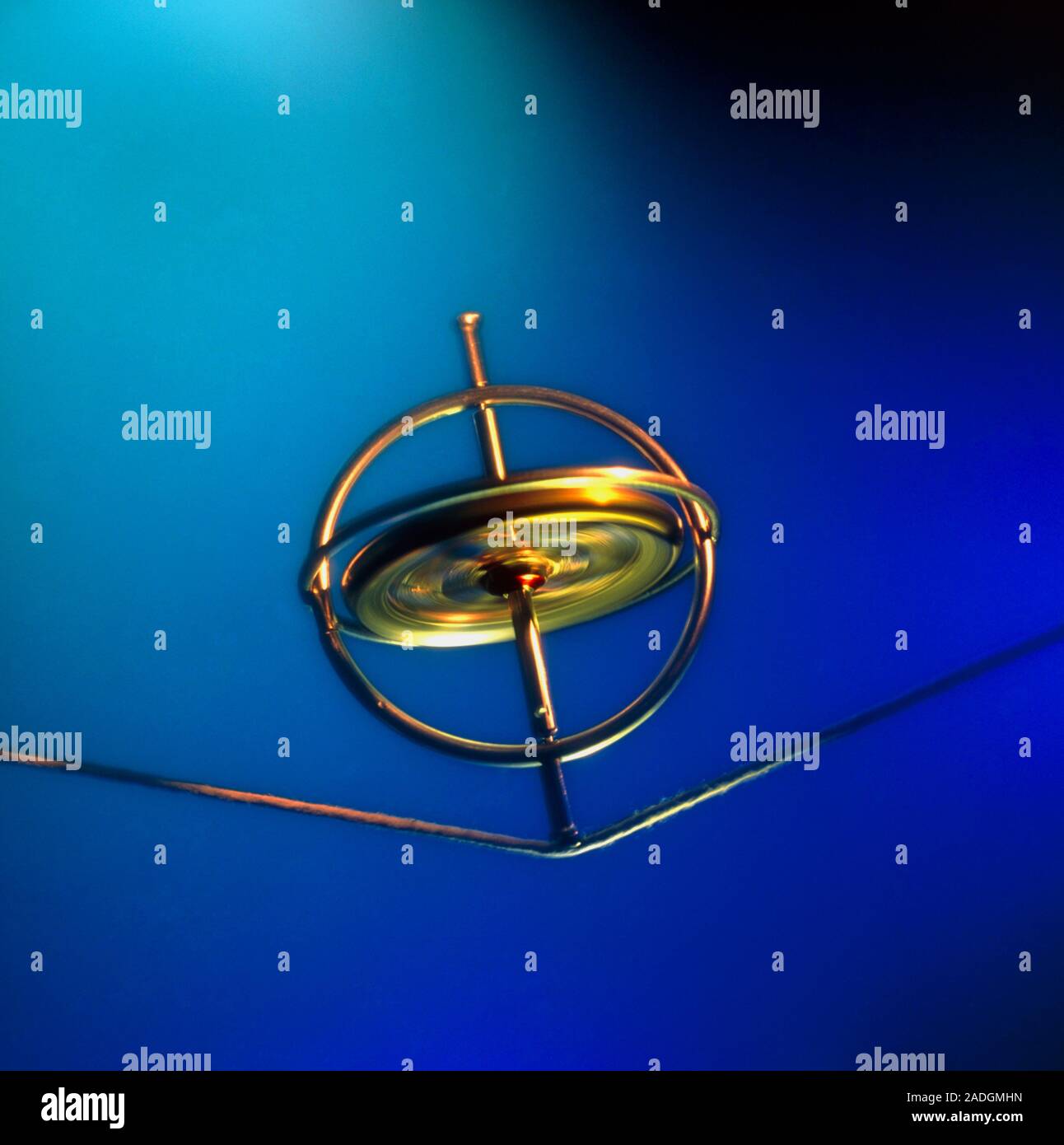 Gyroscope. Toy gyroscope spinning on a piece of string. A gyroscope is ...
