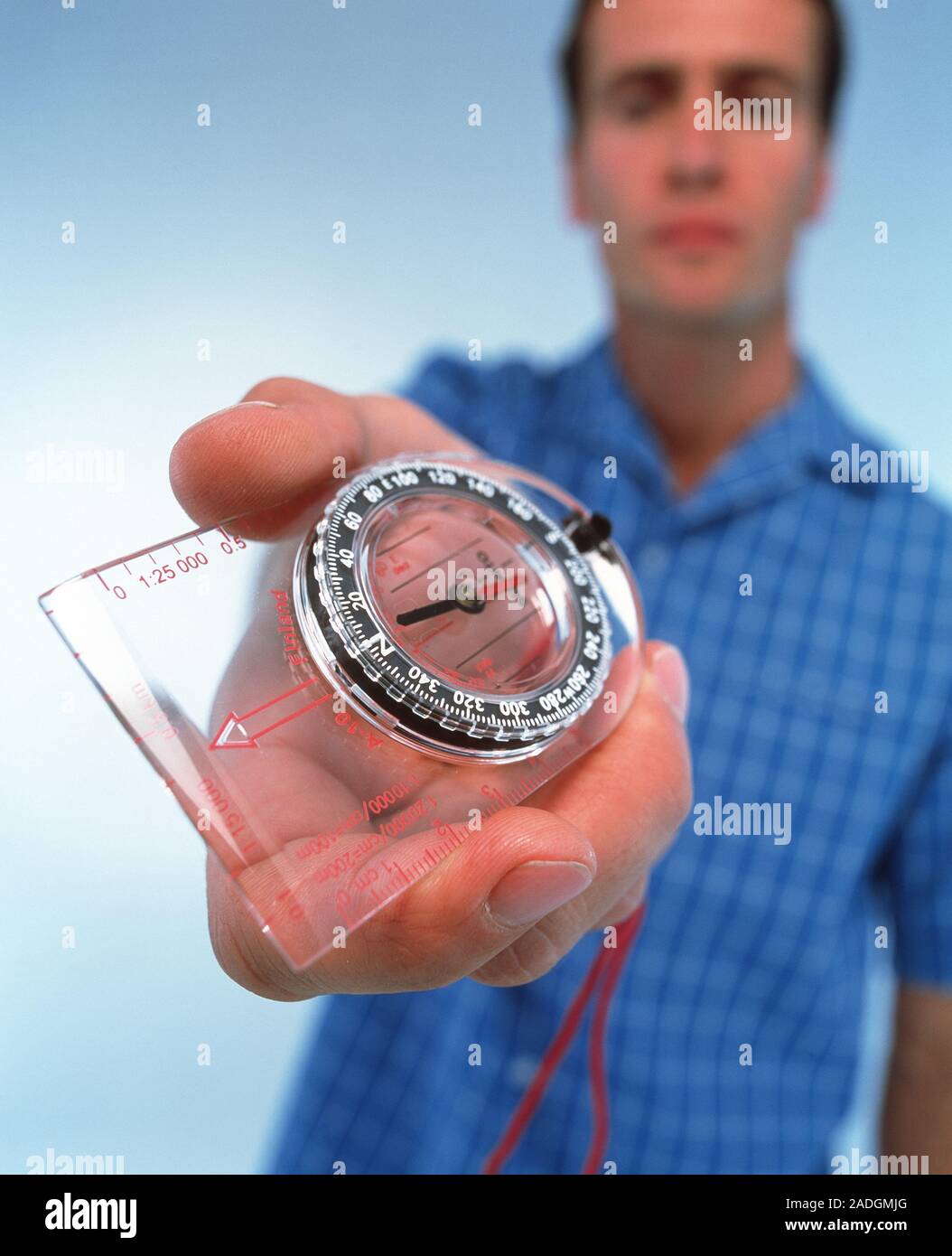 Magnetic compass. Man holding a magnetic compass in his outstretched ...