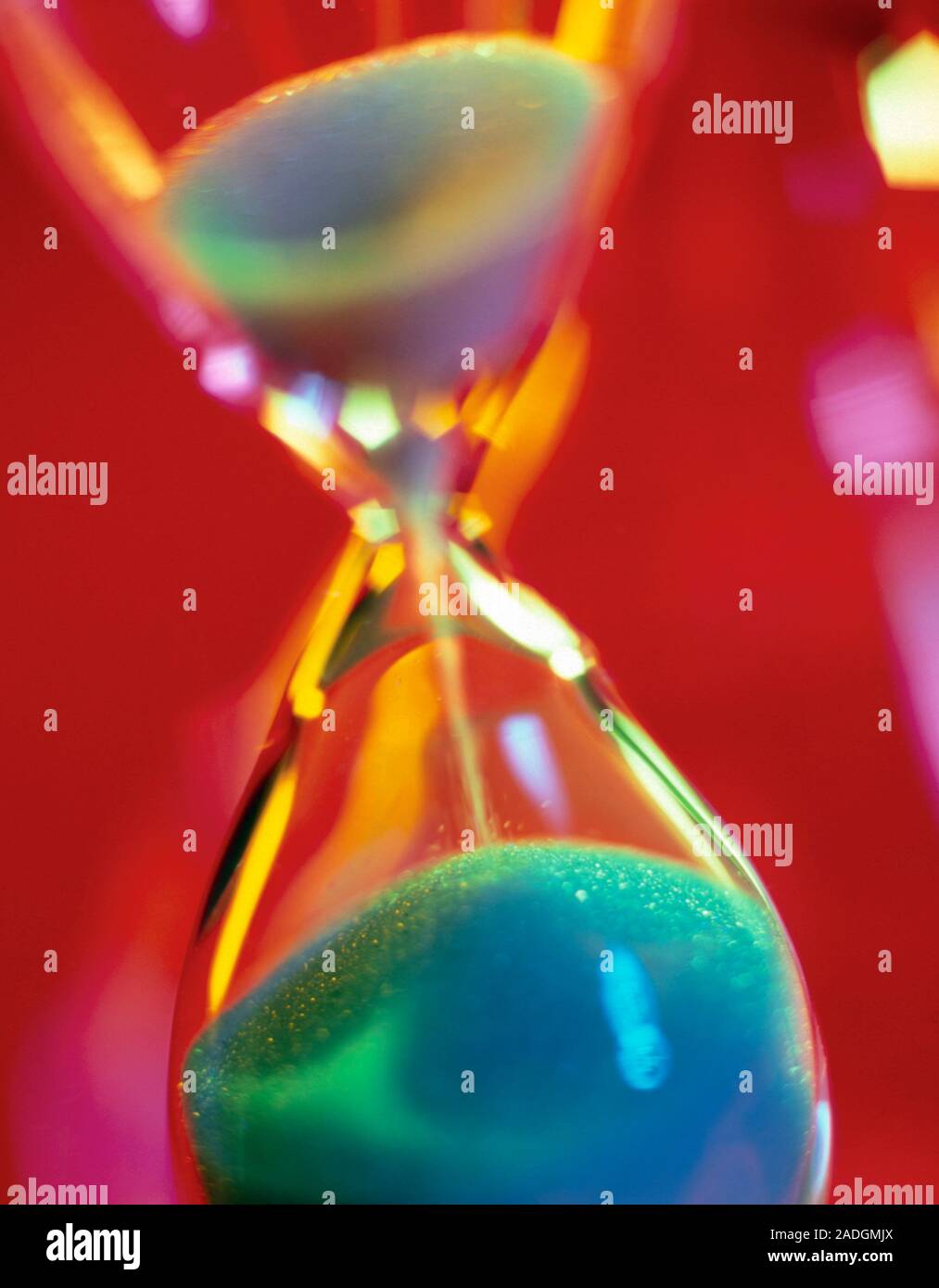 Hourglass. Grains of sand falling through an hourglass Stock Photo - Alamy