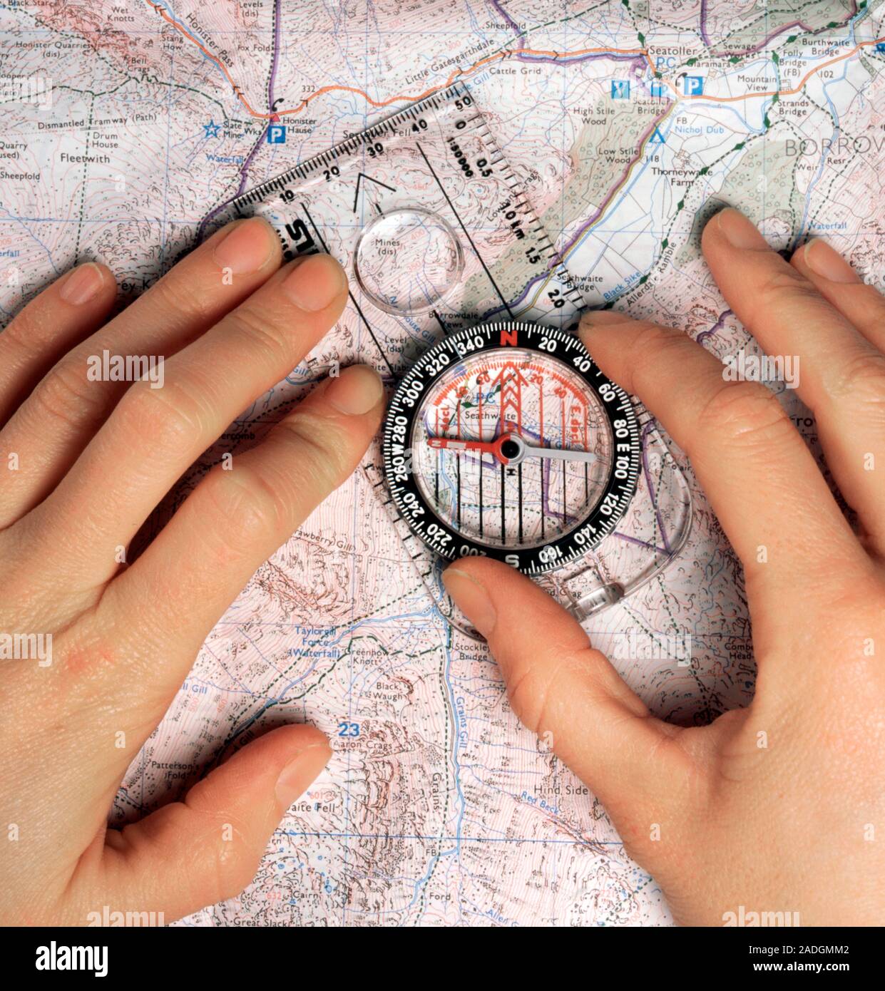 MODEL RELEASED. Magnetic compass and map Stock Photo - Alamy