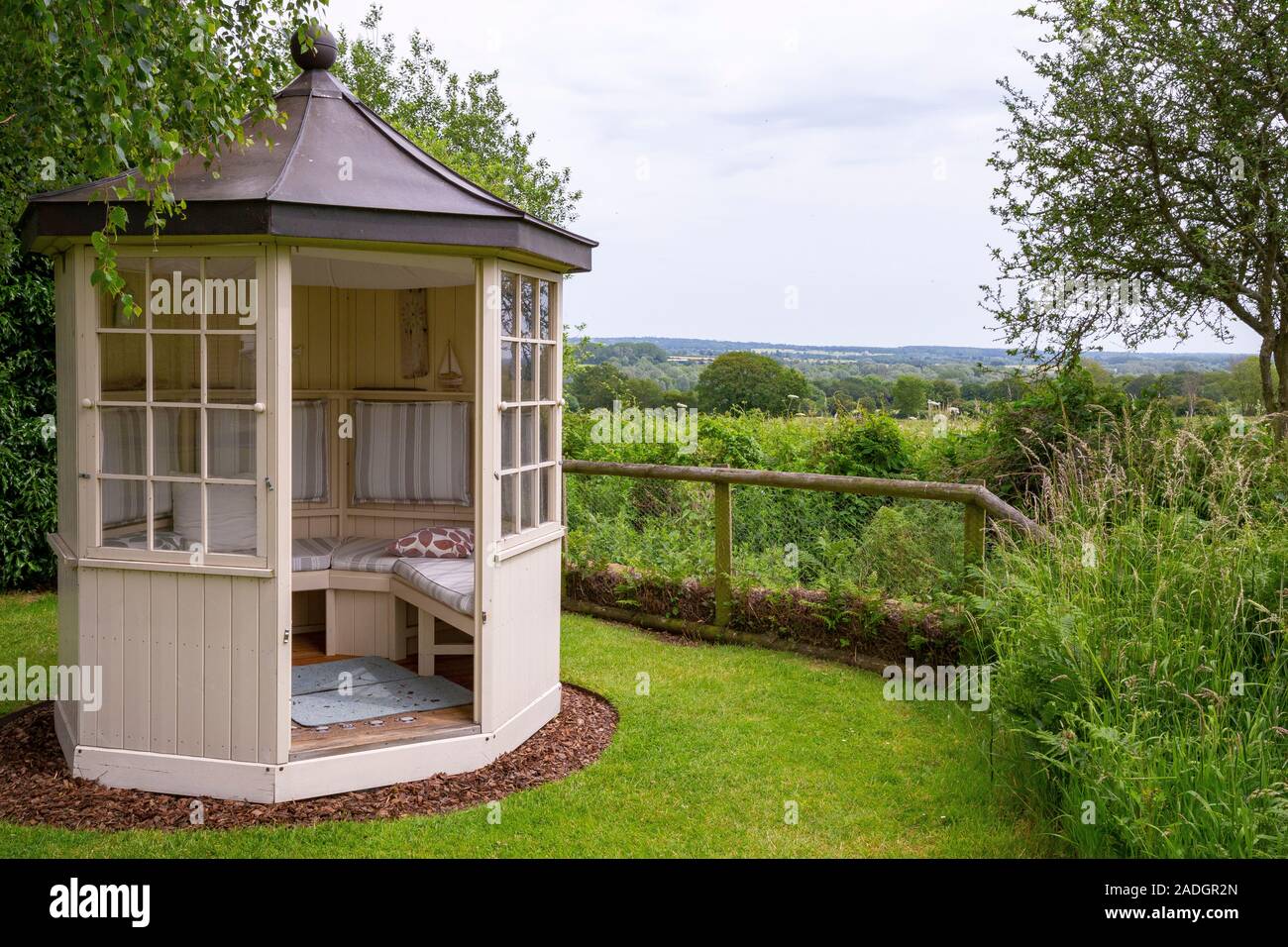 A revolving cream Summer House with view to surrounding countryside ...
