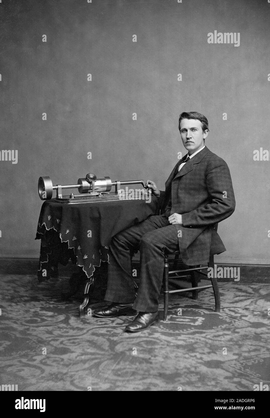 Thomas Edison (1847-1931), American inventor. Edison sitting next to ...
