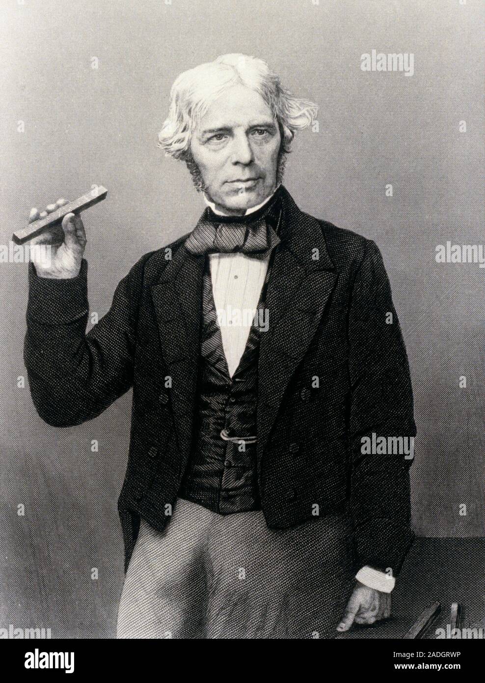 Michael Faraday, English physicist and chemist, (1791 - 1867) holding a ...