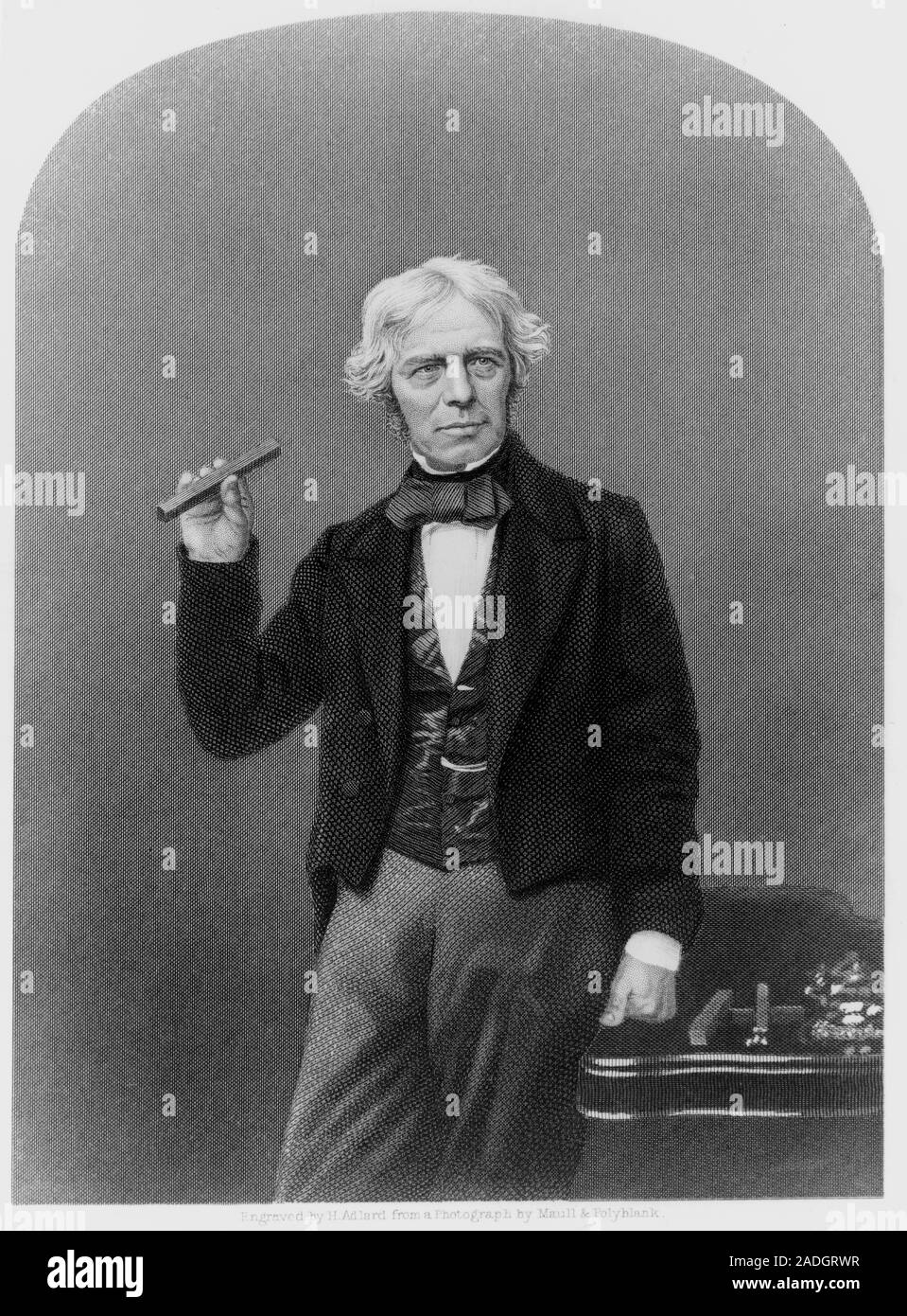 Michael Faraday, English physicist and chemist, (1791 - 1867) holding a ...