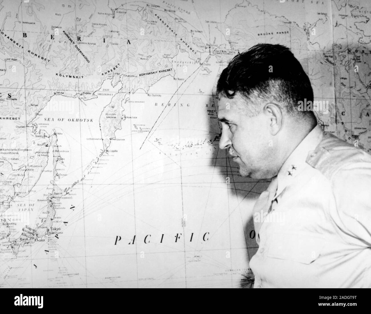 Major General Leslie R. Groves studying a map of Japan. Groves was head ...