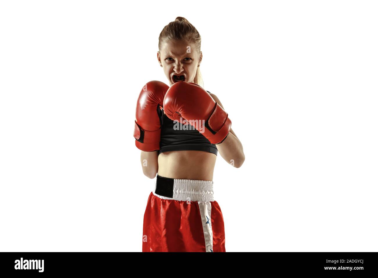 Young female kickboxing fighter training isolated on white background ...