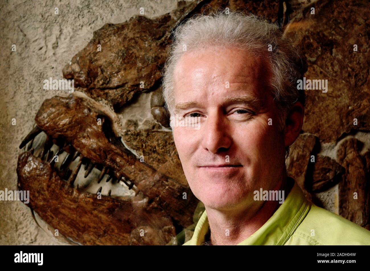 Timothy Rowe, US palaeontologist, standing in front of a fossil ...