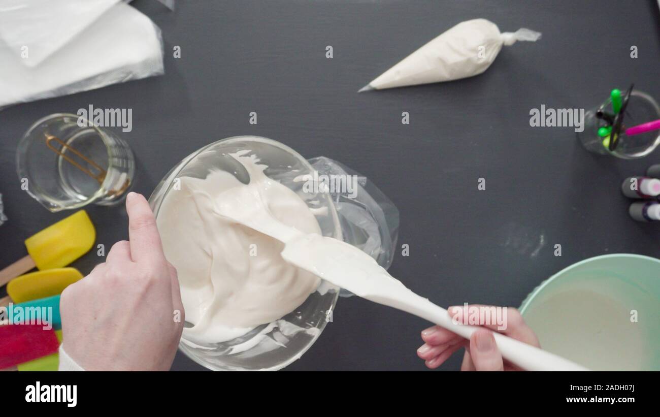 Step by step. Flat lay. Pouring royal icing into the piping bag to ...