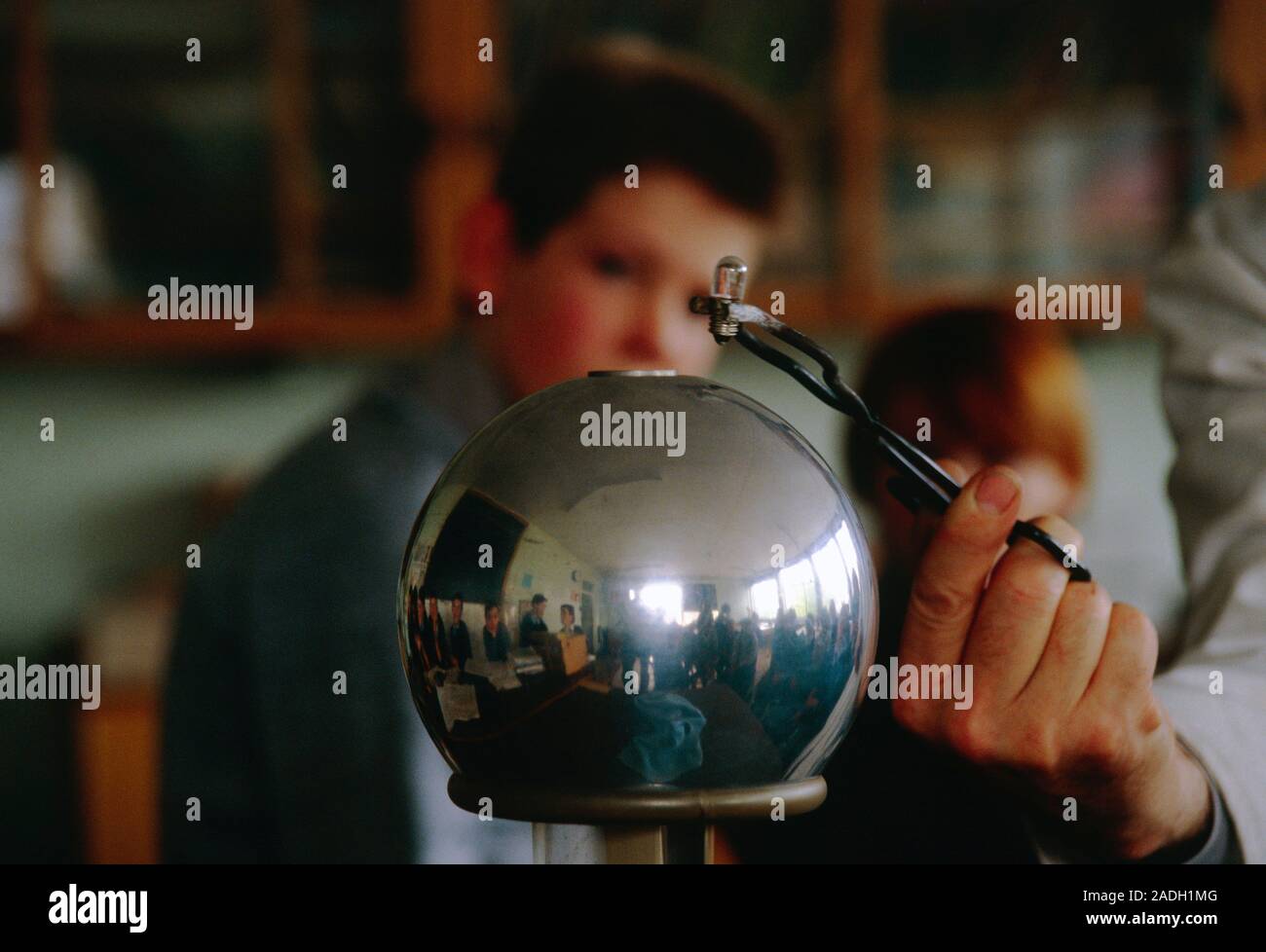 A teacher demonstrates to his secondary school physics class how static ...