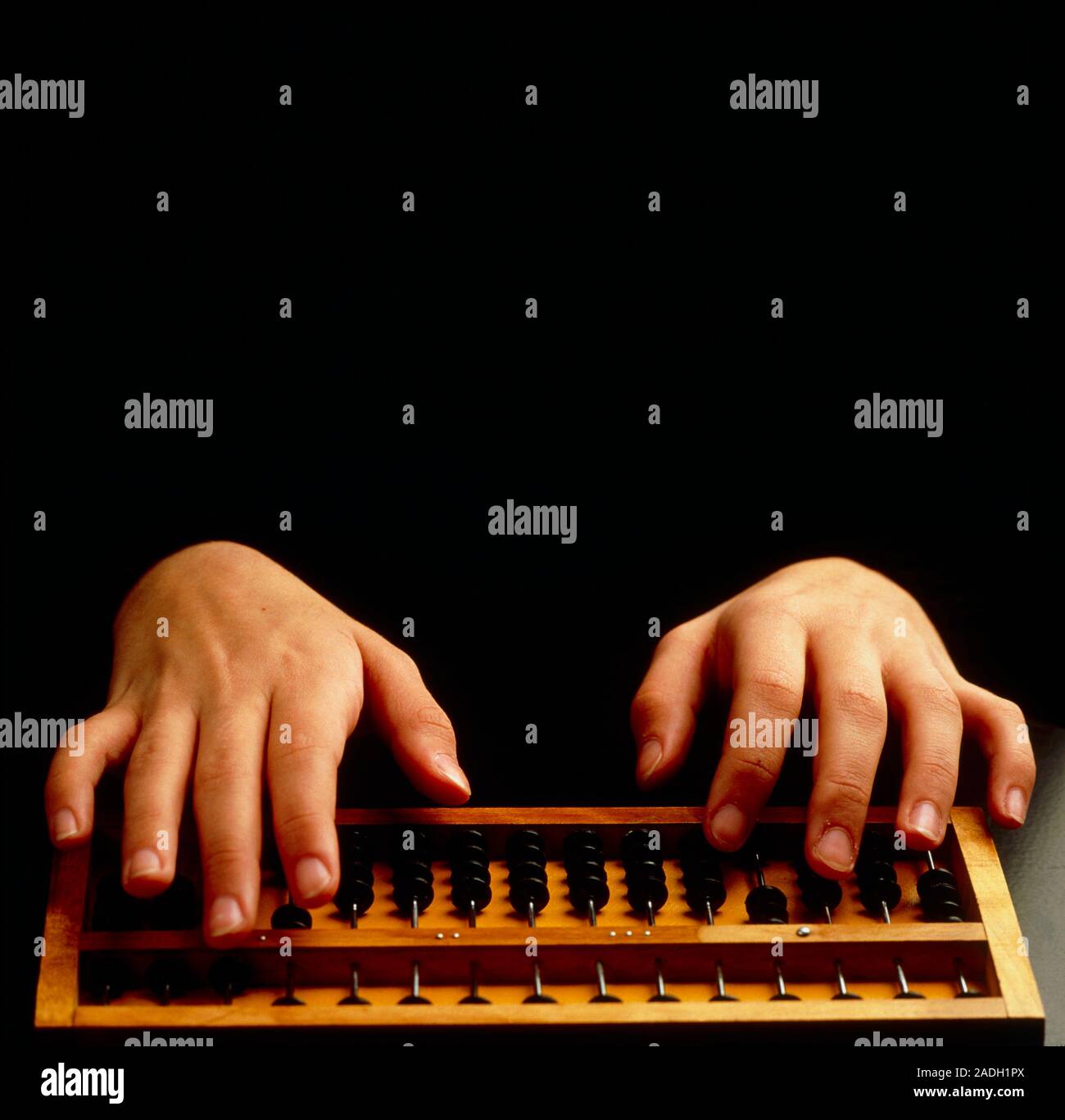 Abacus. Hands carrying out a calculation using an abacus. An abacus is ...