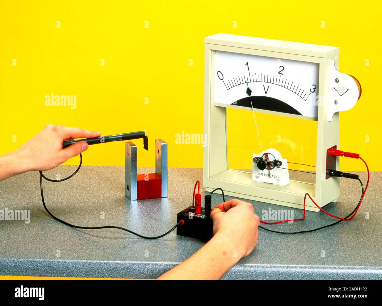 Physics experiment. Pupil's hands using apparatus to demonstrate the ...