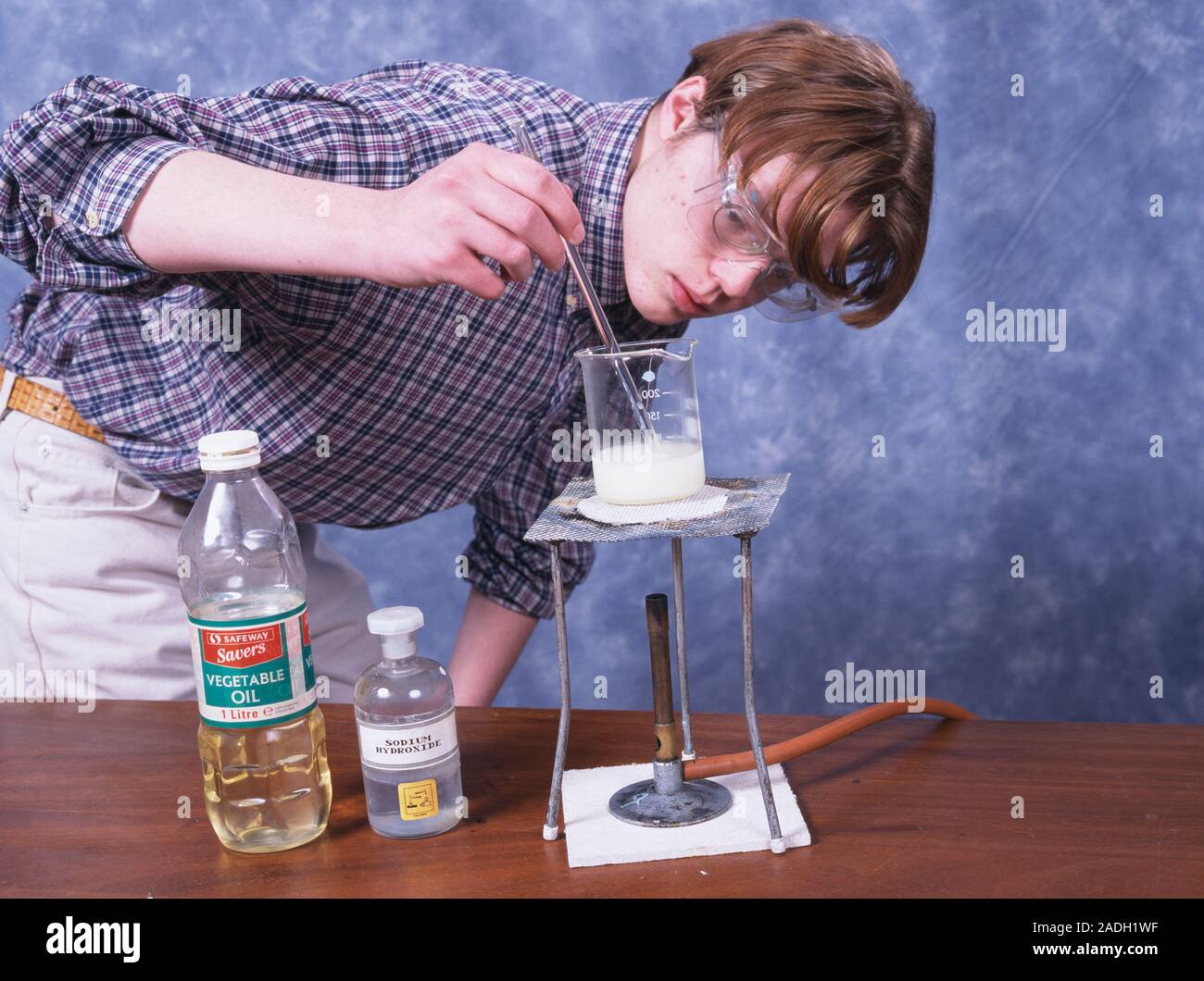 Student making soap in the laboratory from vegetable oil and sodium ...